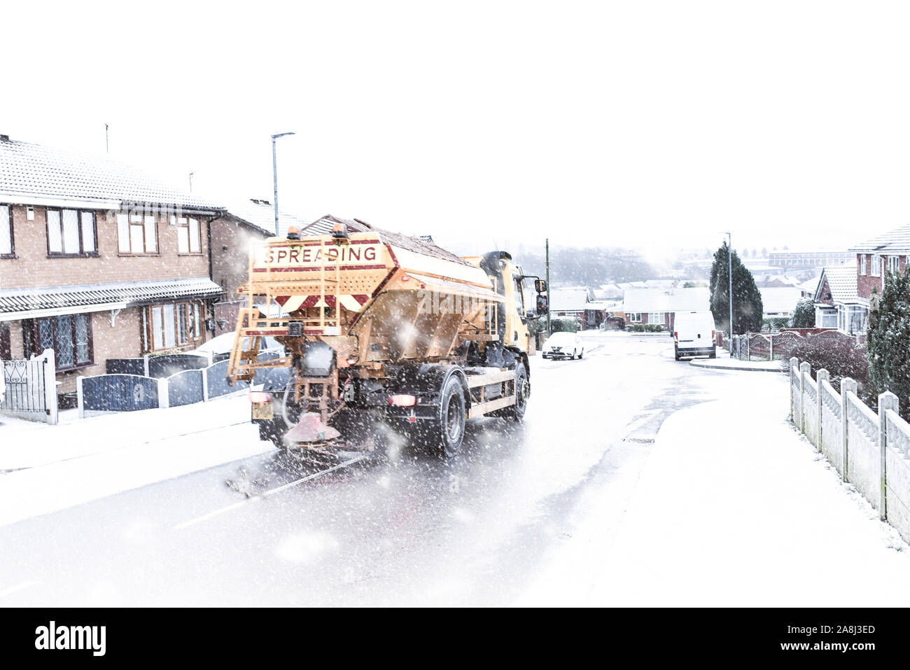 A gritting lorry travelling through heavy snow gritting the dangerous ...
