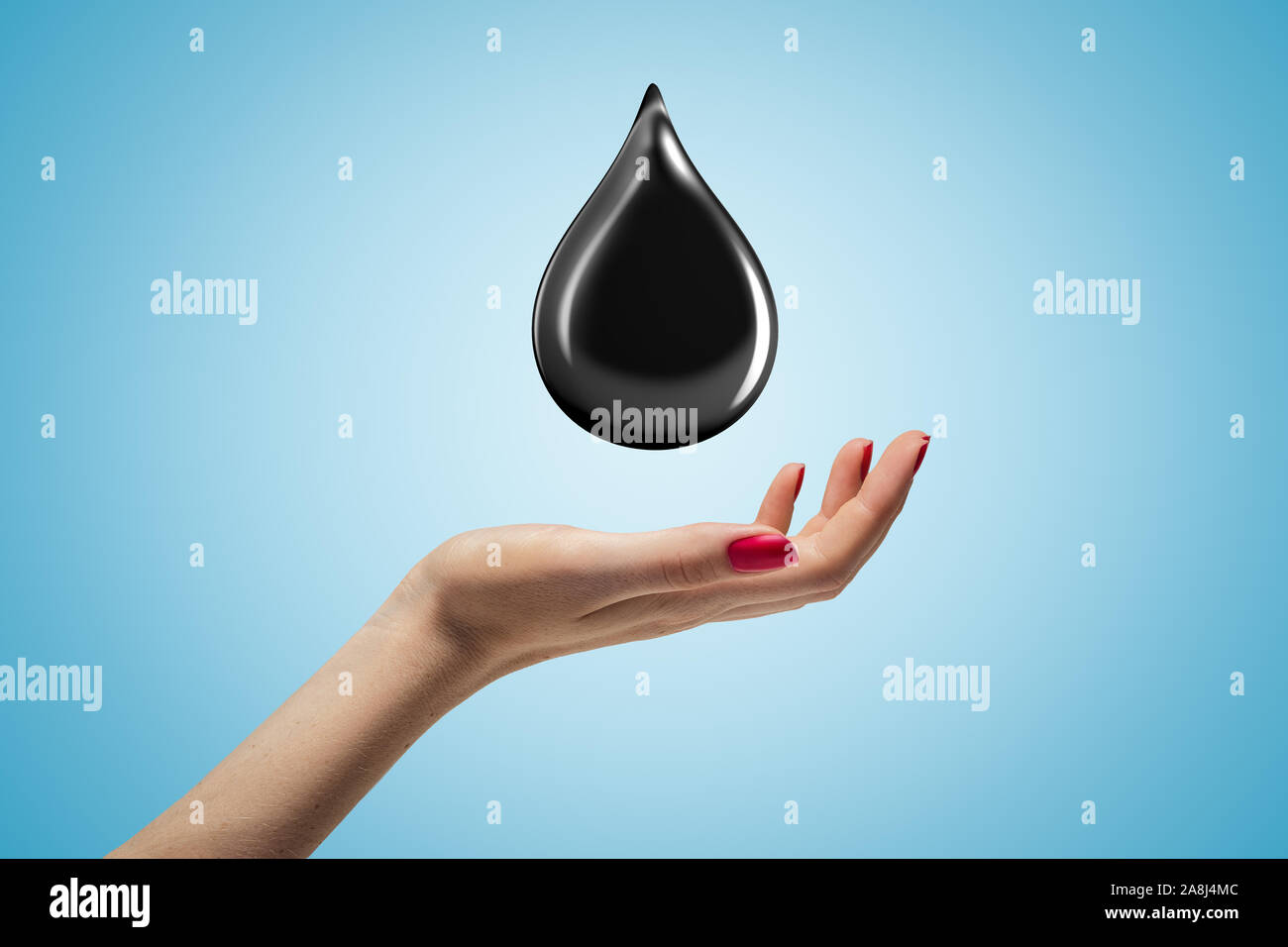Female hand with black oil drop on blue sky background Stock Photo - Alamy