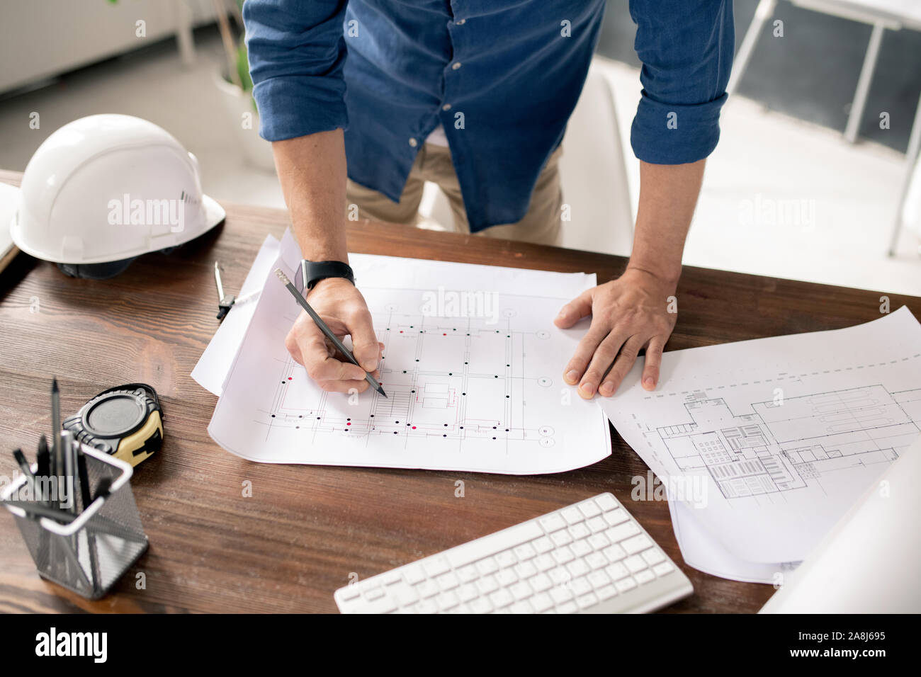 Hands of contemporary architect with pencil or crayon drawing sketch on ...