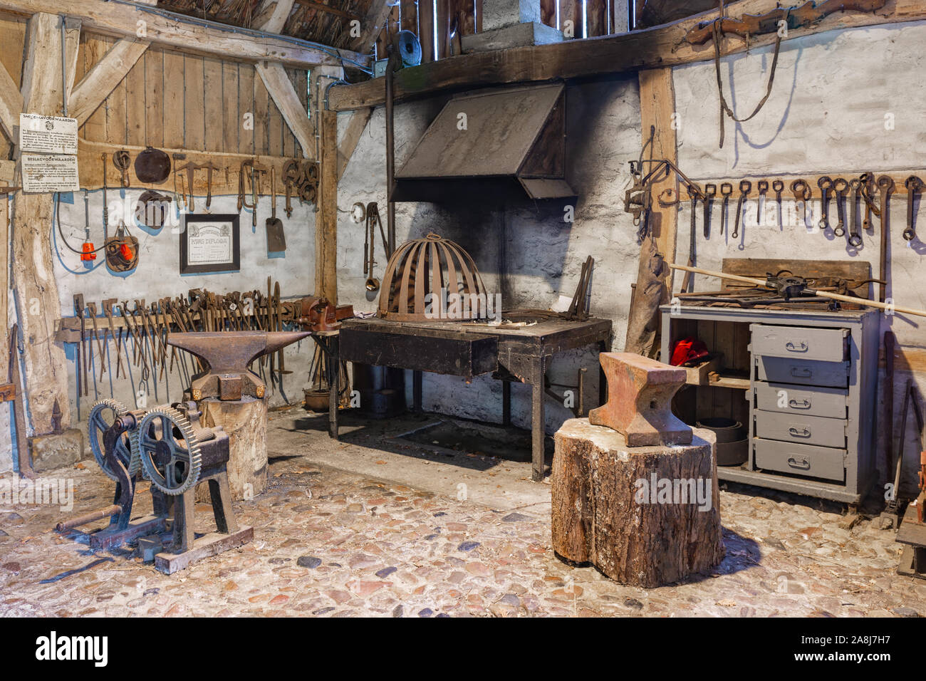 Dutch rural open-air museum, forge with anvil and old historical tools ...
