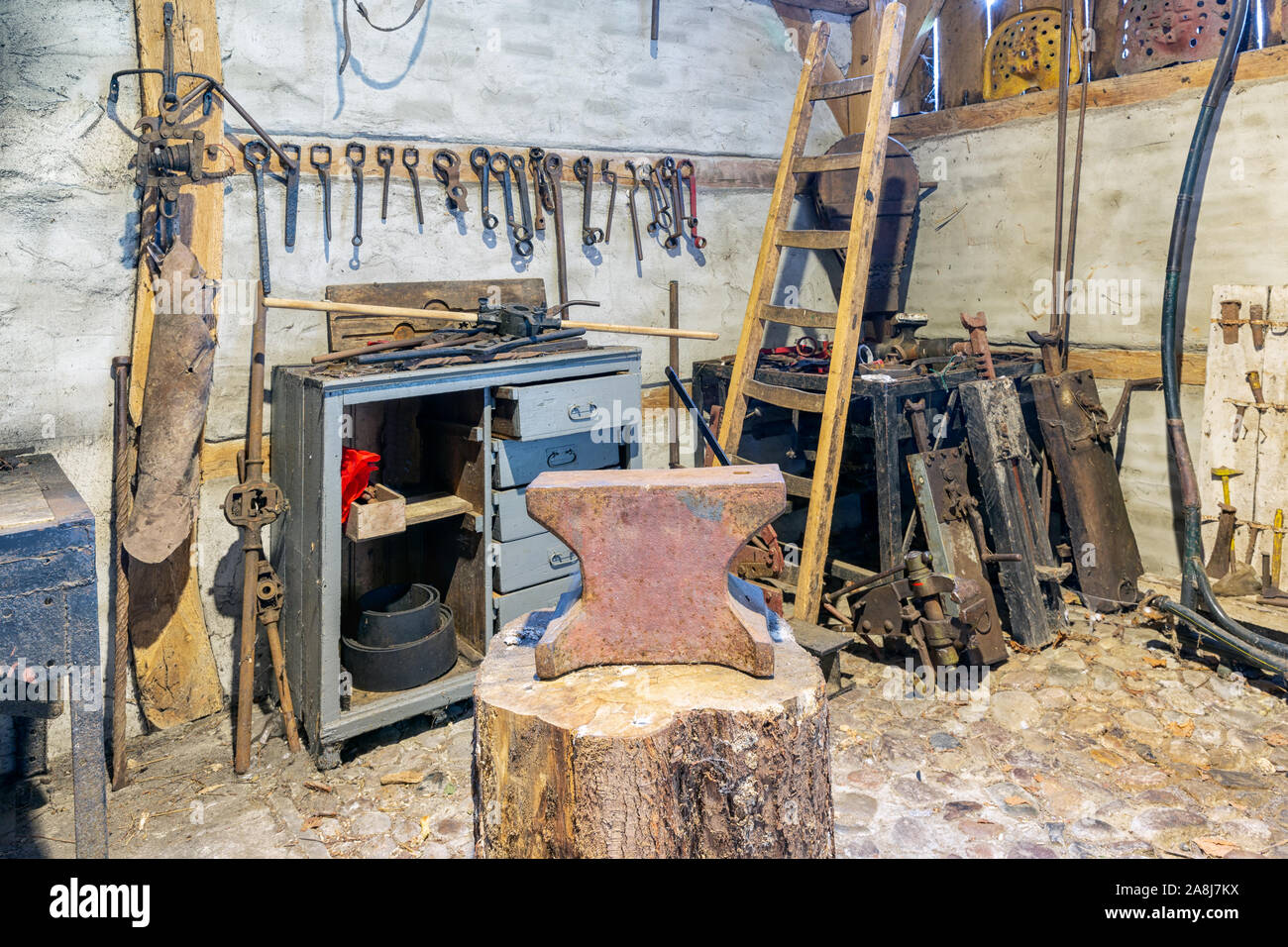 Dutch rural open-air museum, forge with anvil and old historical tools ...