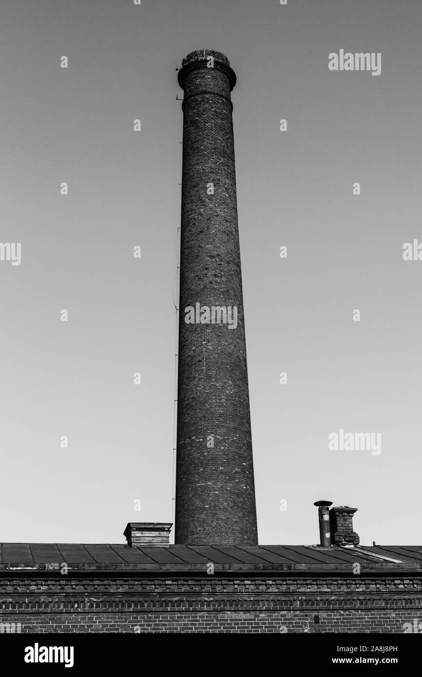 Chimney next to the old water tower Stock Photo - Alamy