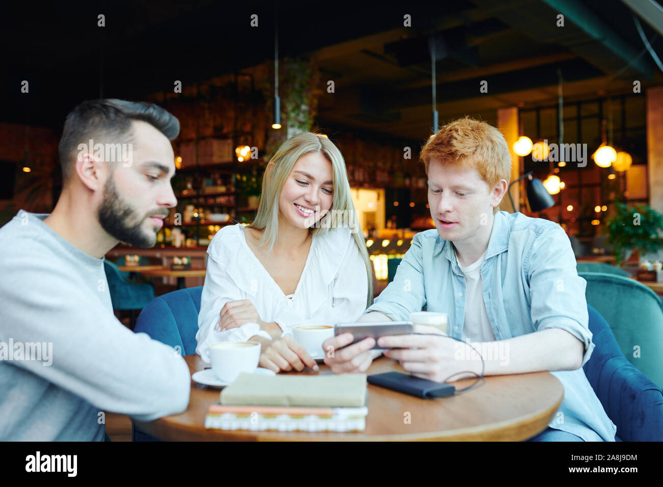 Two young men sitting cafe friends hi-res stock photography and images ...