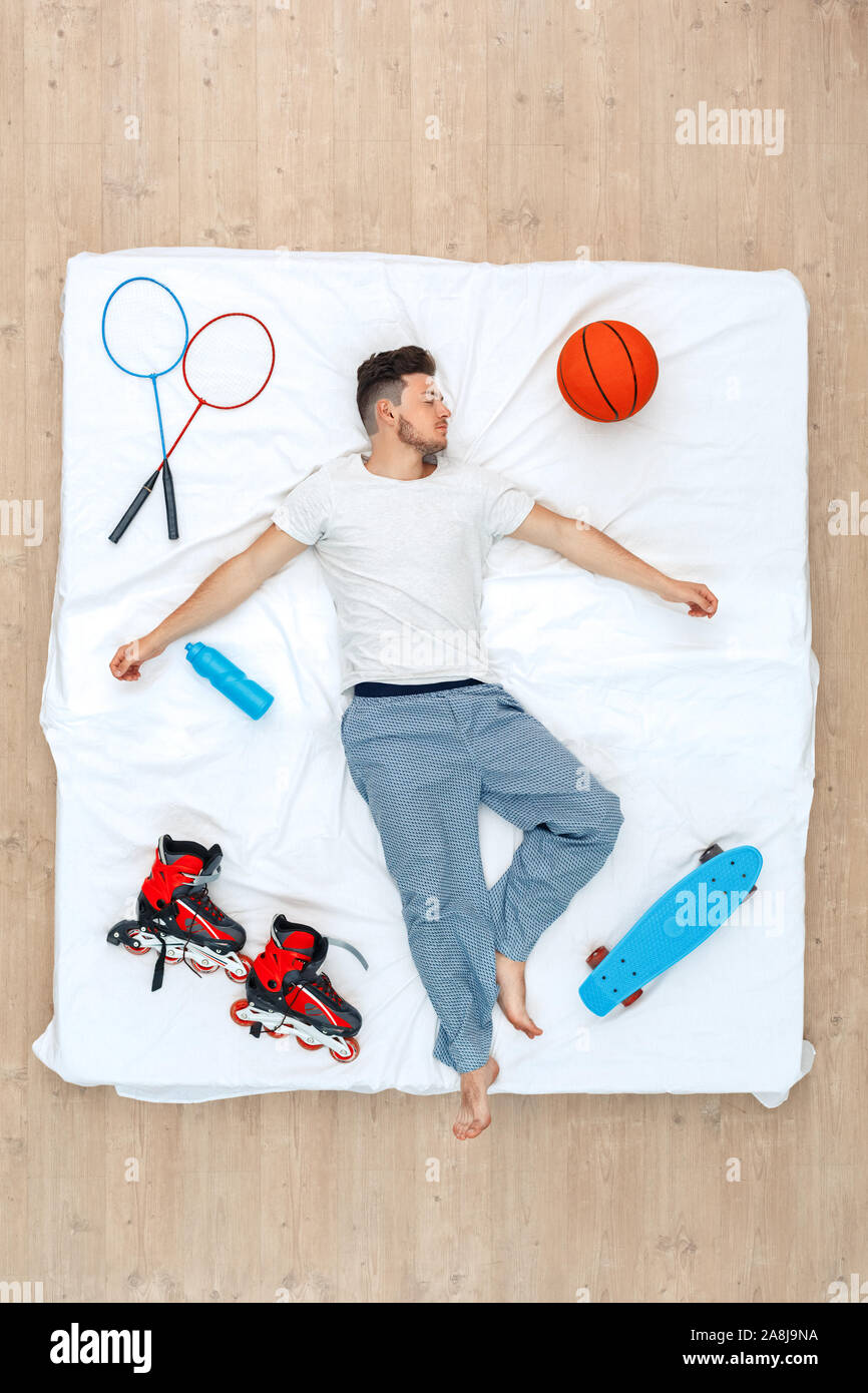 Bedtime. Guy lying on bed top view Stock Photo - Alamy