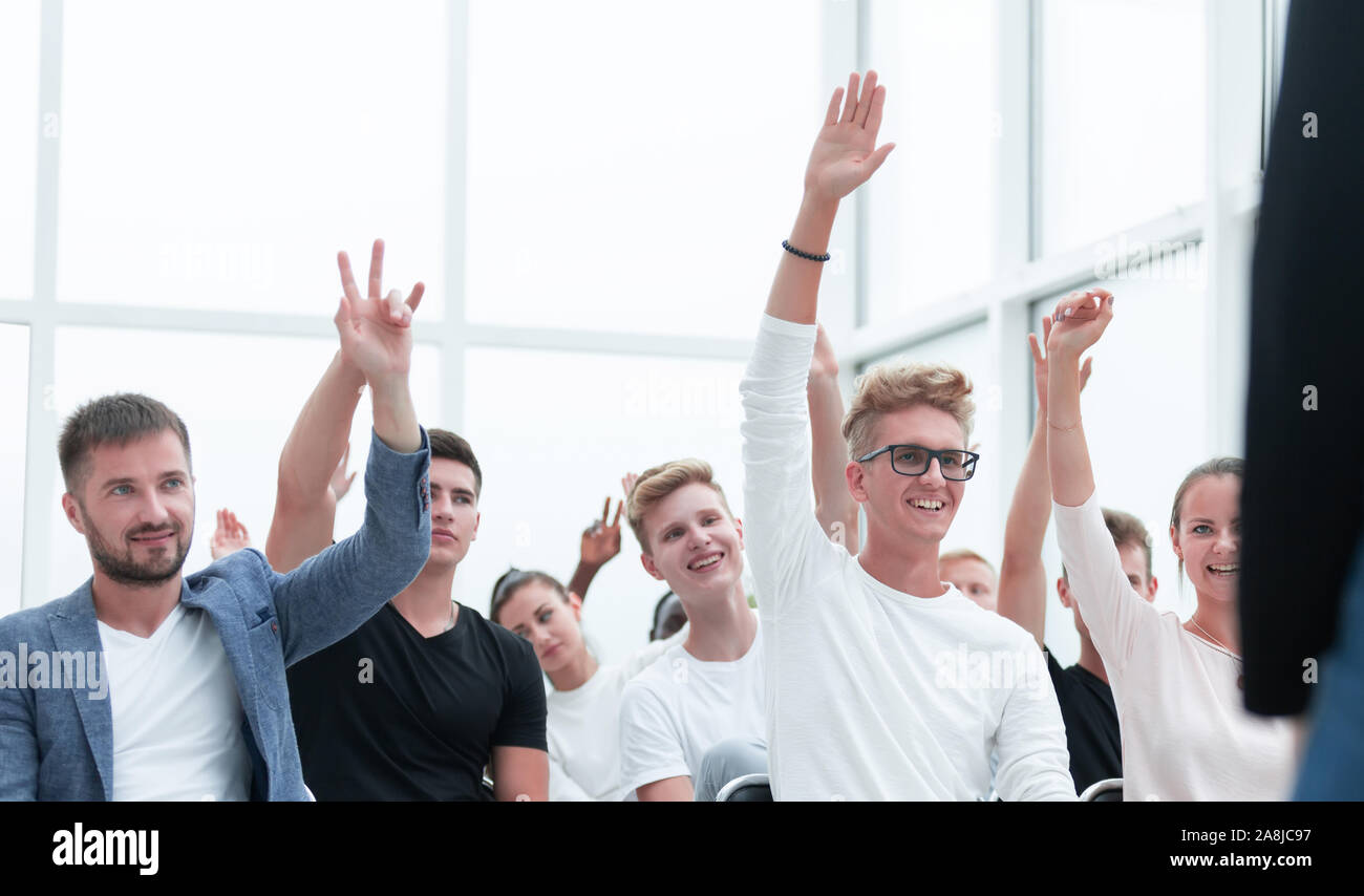 group of young people raising their hands to ask a question Stock Photo ...