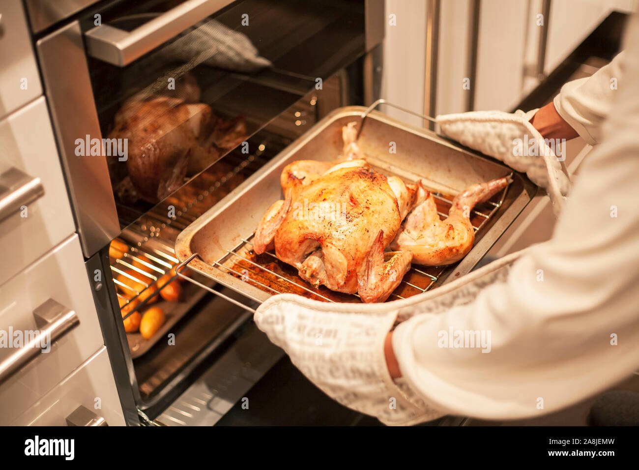 Woman cooking whole baked chicken hi-res stock photography and images ...