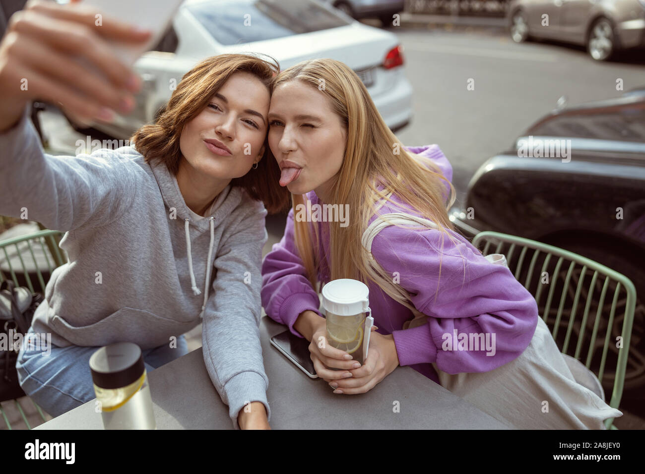 Positive delighted girls making faces on camera Stock Photo - Alamy