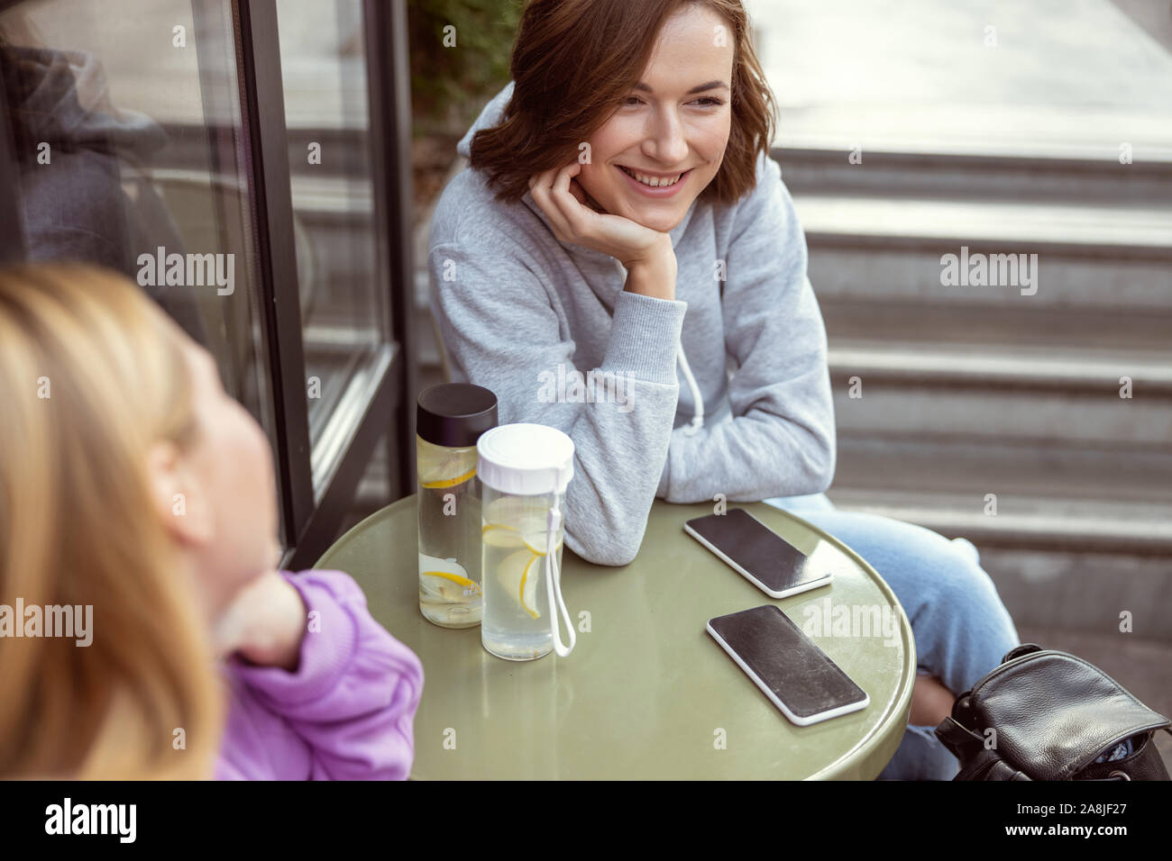 Kind brunette girl demonstrating her friendly smile Stock Photo - Alamy
