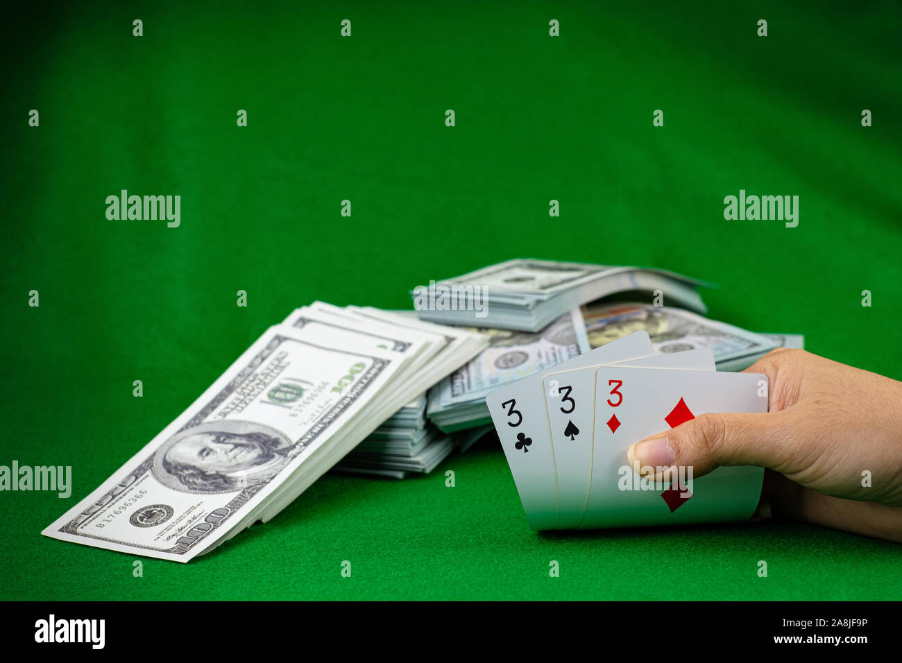 Poker casino gambling and the money stack of 100 US dollars banknotes ...