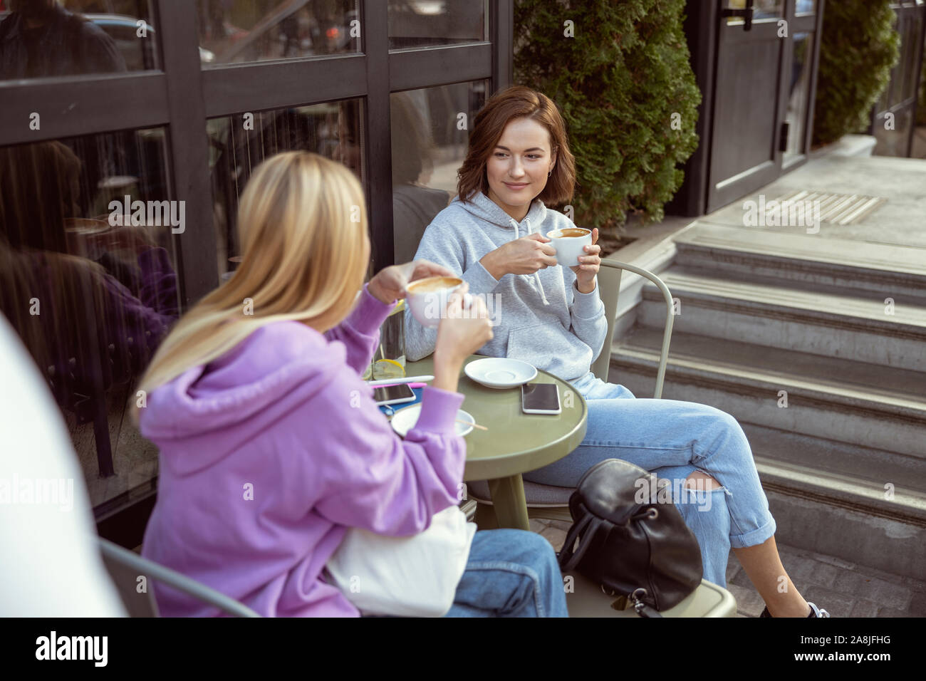 Two relaxed females enjoying their friendly communication Stock Photo ...