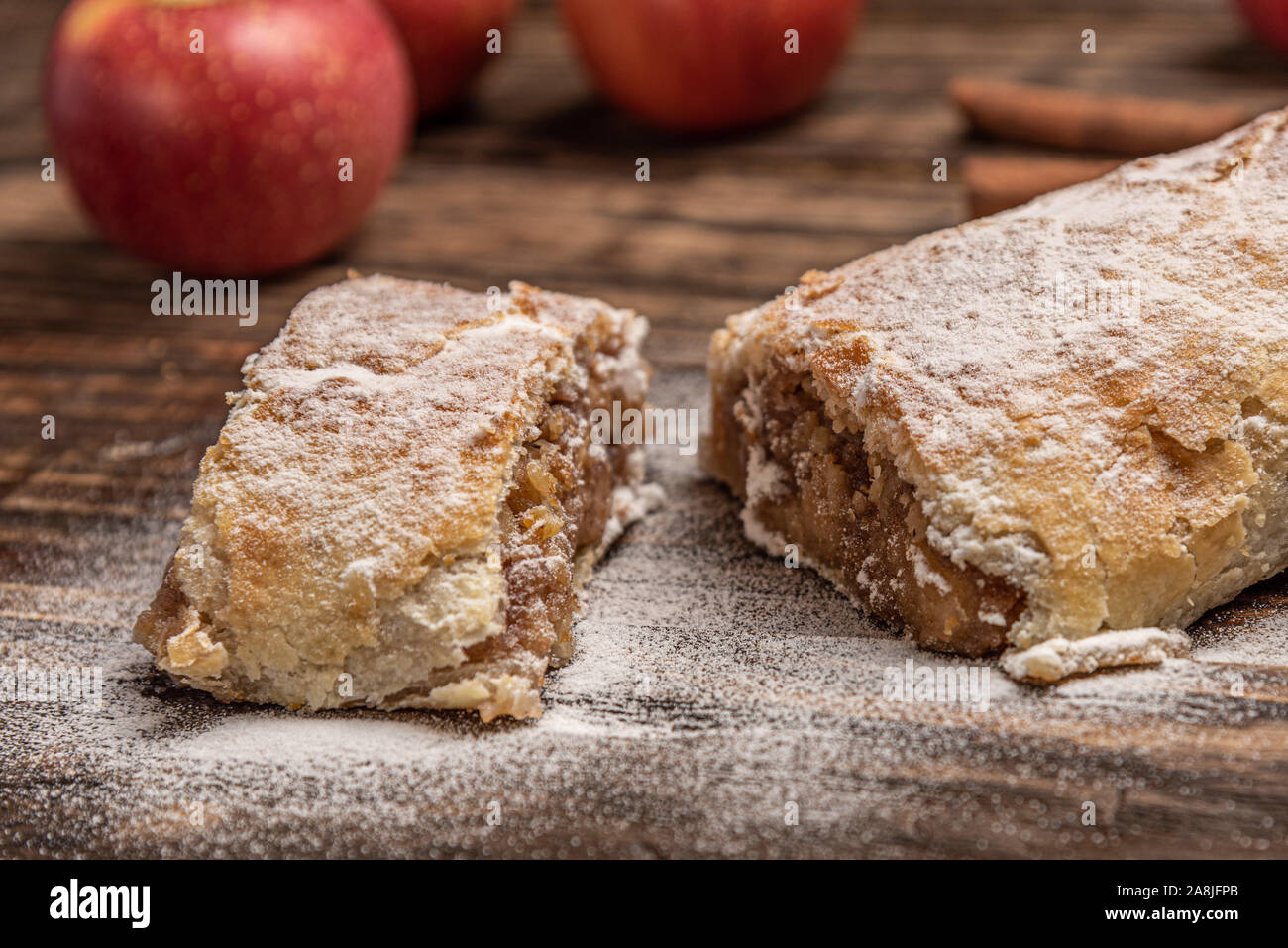Traditional apple strudel with powdered sugar on wooden rustic ...