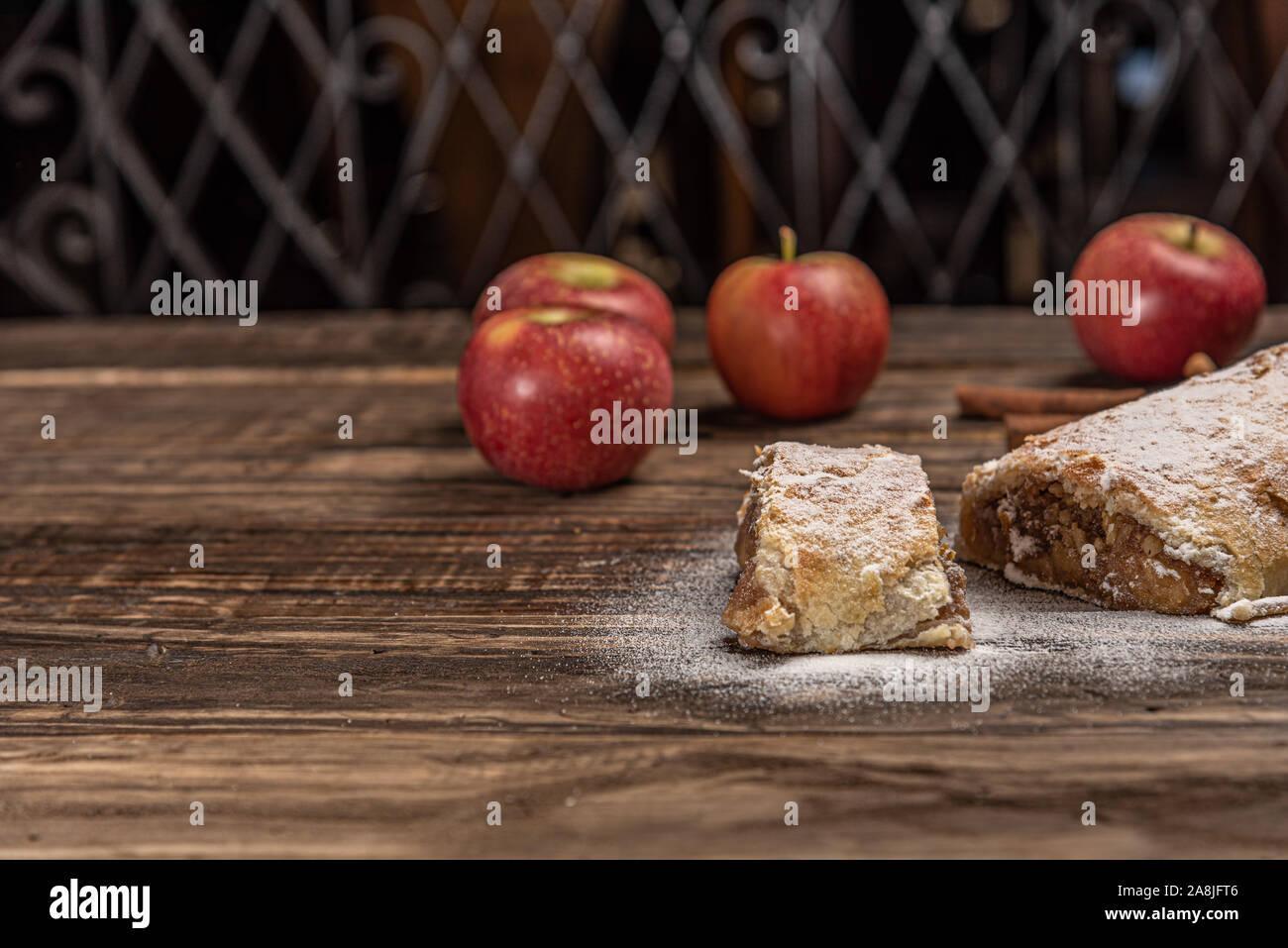 Traditional apple strudel with powdered sugar on wooden rustic ...