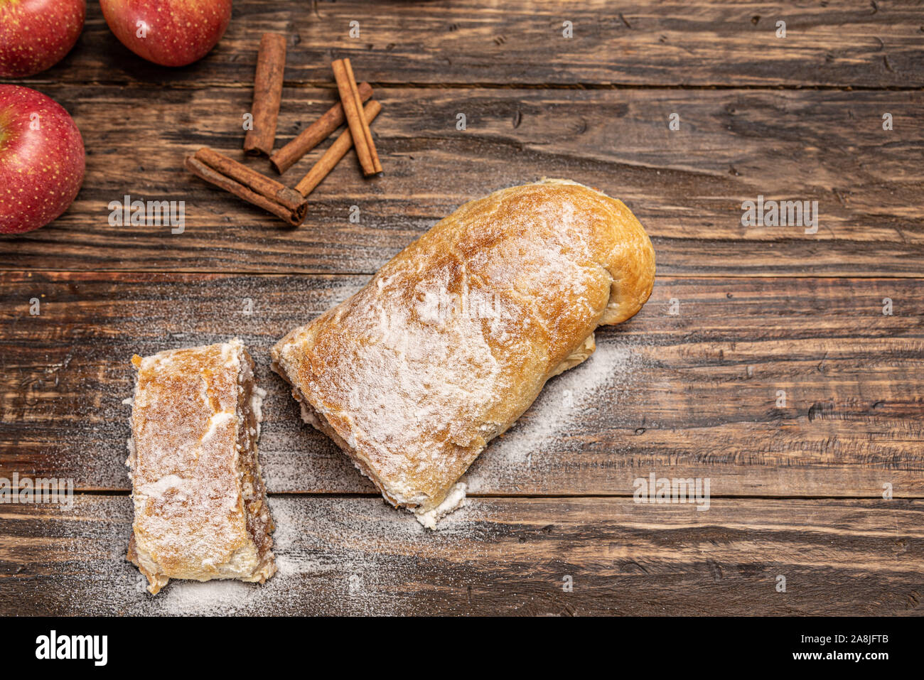 Traditional apple strudel with powdered sugar on wooden rustic ...