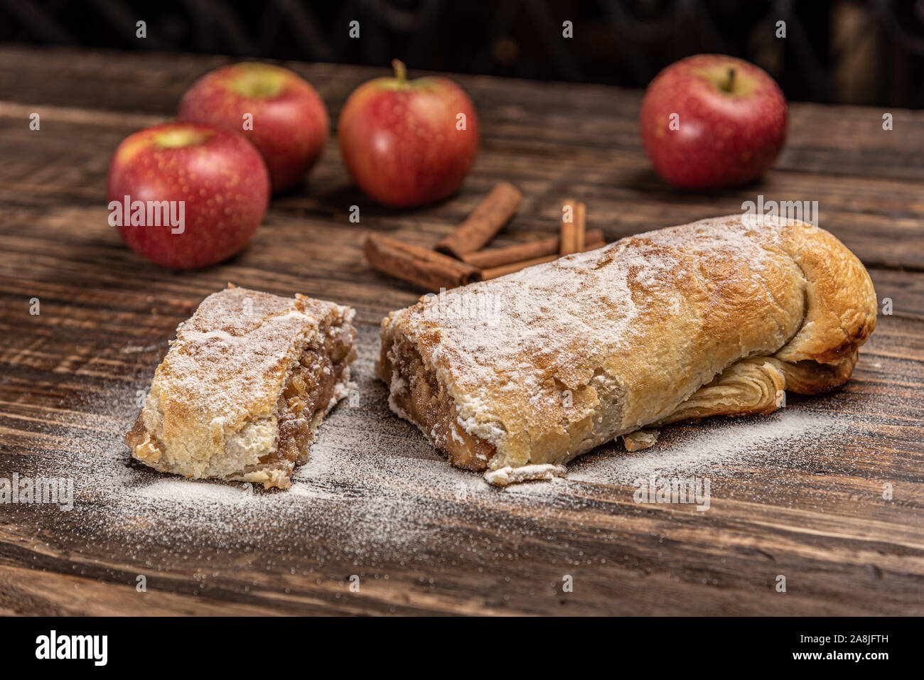 Traditional apple strudel with powdered sugar on wooden rustic ...