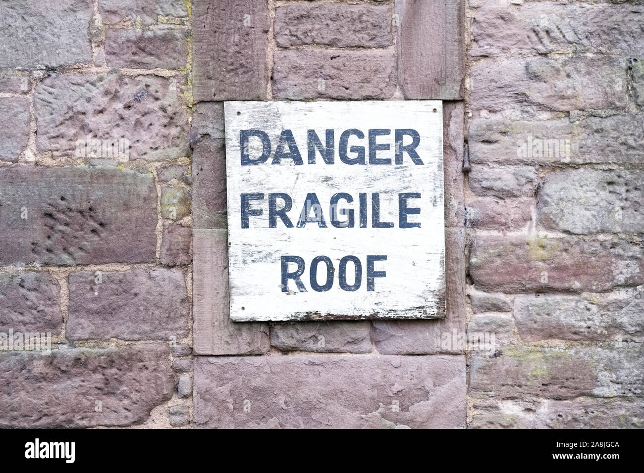 Danger fragile roof sign on wall at farm house Stock Photo - Alamy