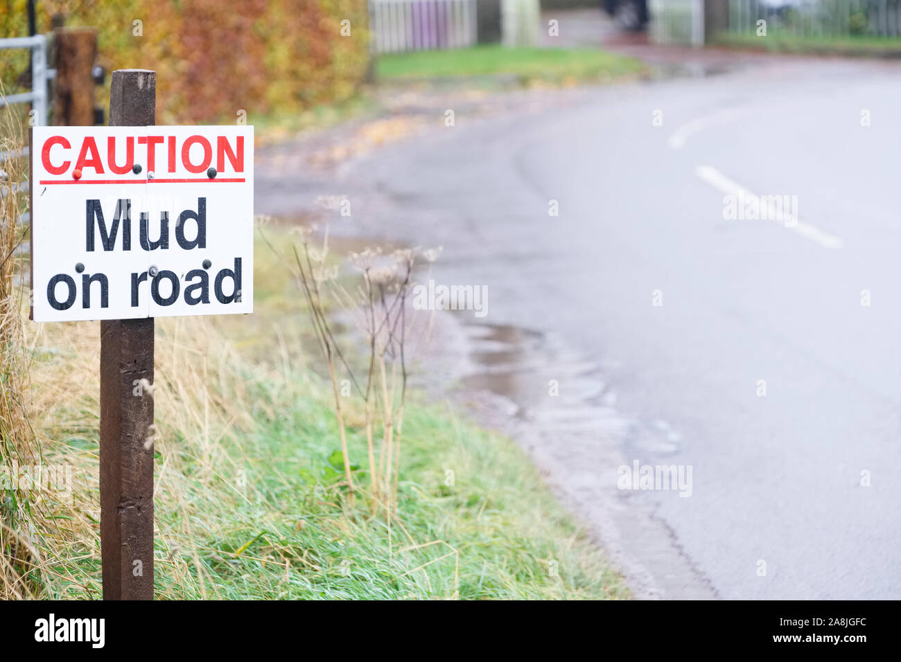 Caution mud on road sign at bend Stock Photo - Alamy