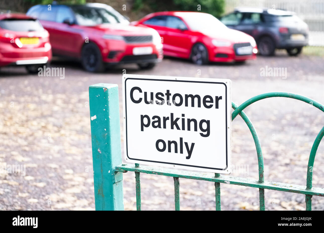 Customer parking only sign on car park staff gate at place of work ...