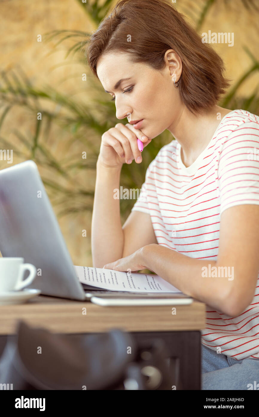 Thoughtful female reading task before visiting classes Stock Photo - Alamy