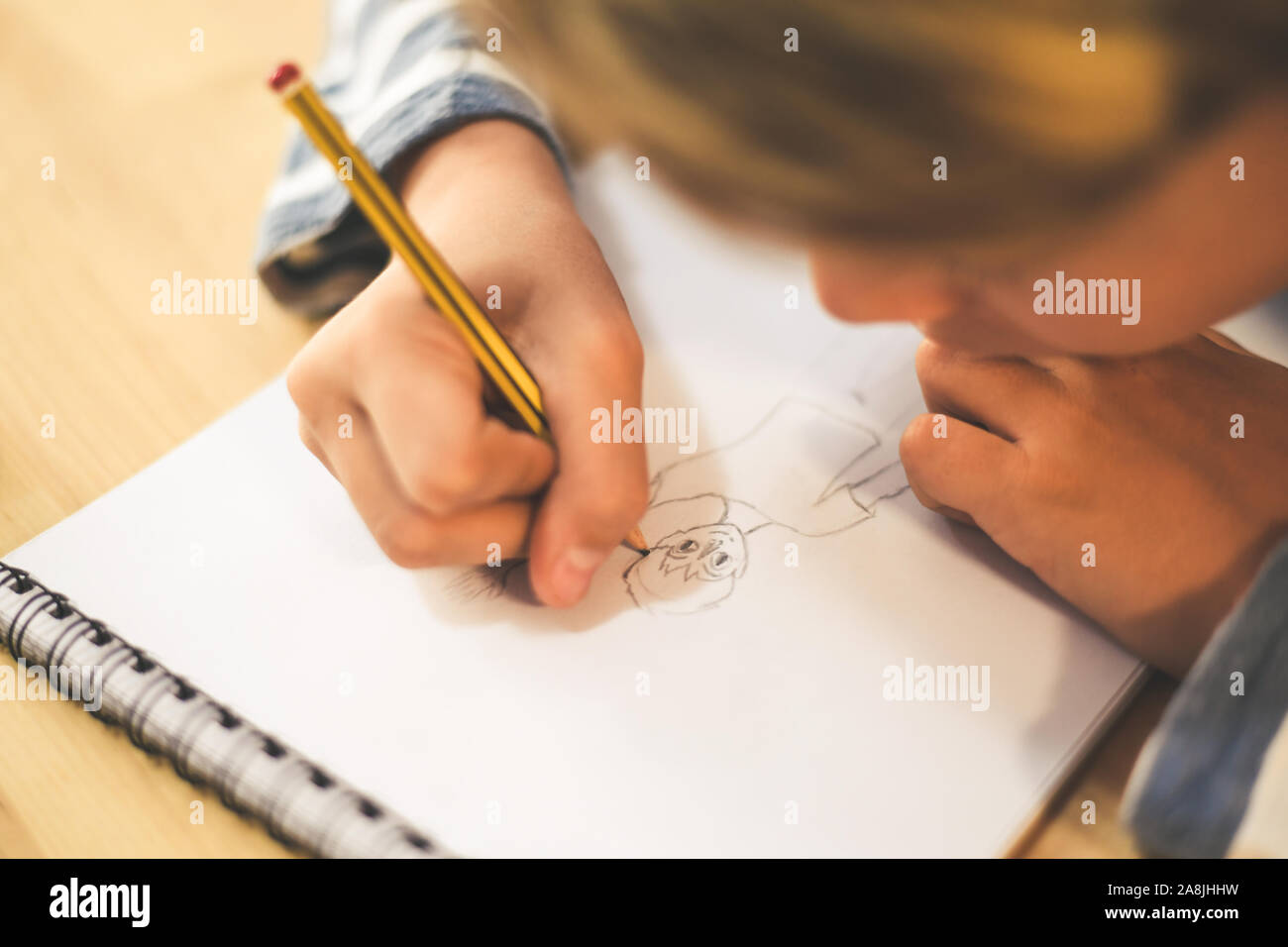 Close up view of student drawing with pencil. Boy doing homework ...