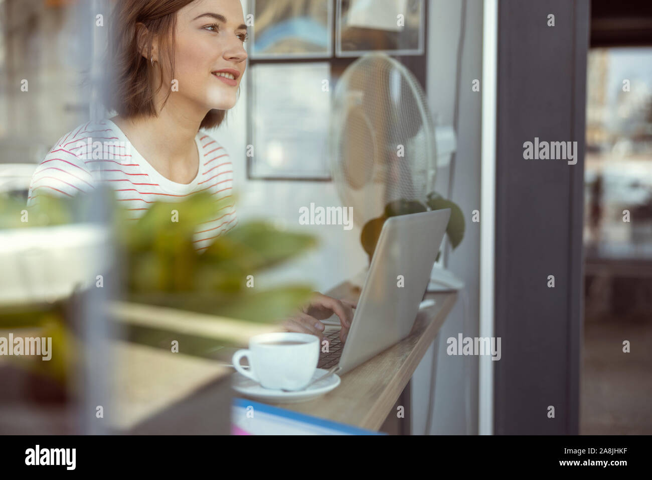 Thoughtful young woman creating plan for project Stock Photo - Alamy