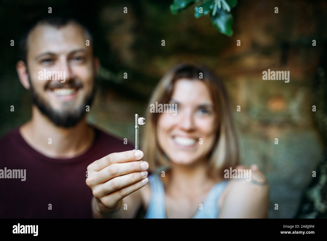 Stock photo of a young couple showing a key Stock Photo - Alamy