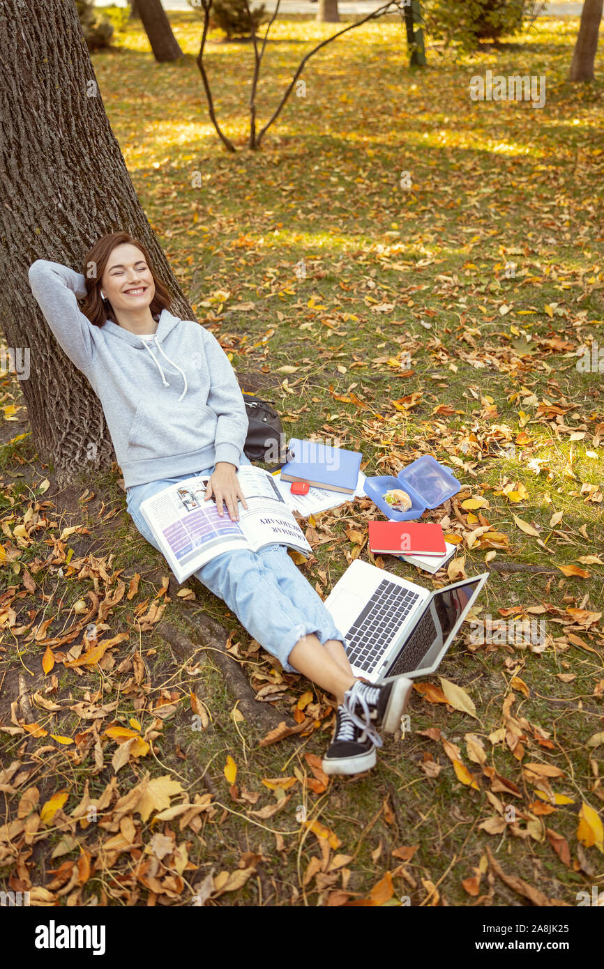 Positive delighted girl having rest in park Stock Photo - Alamy