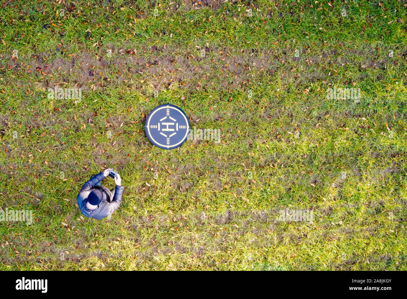 Drone operator aerial view with landing and take off target pad must ...