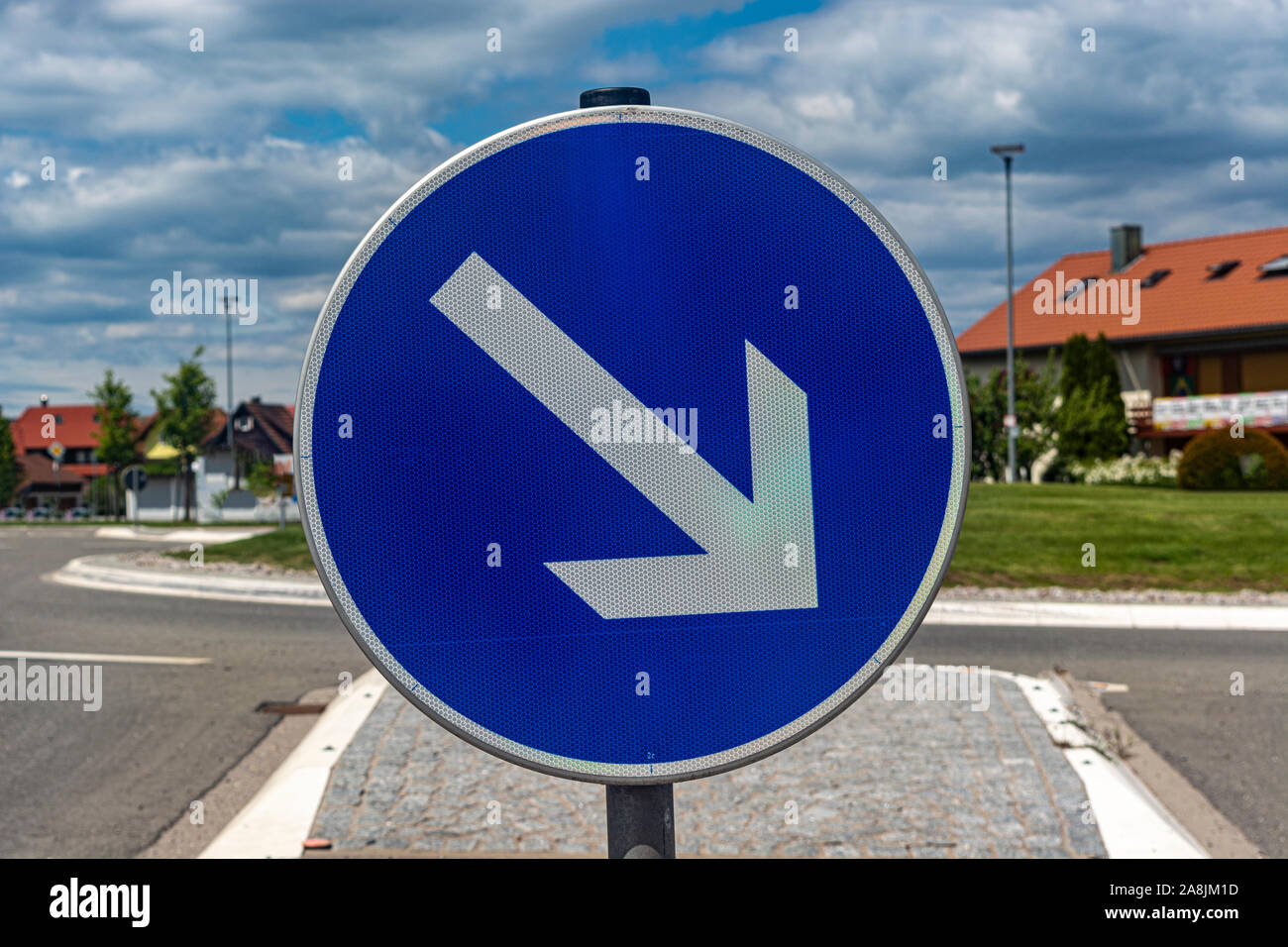road round blue arrow sign. close up. blue sky Stock Photo - Alamy