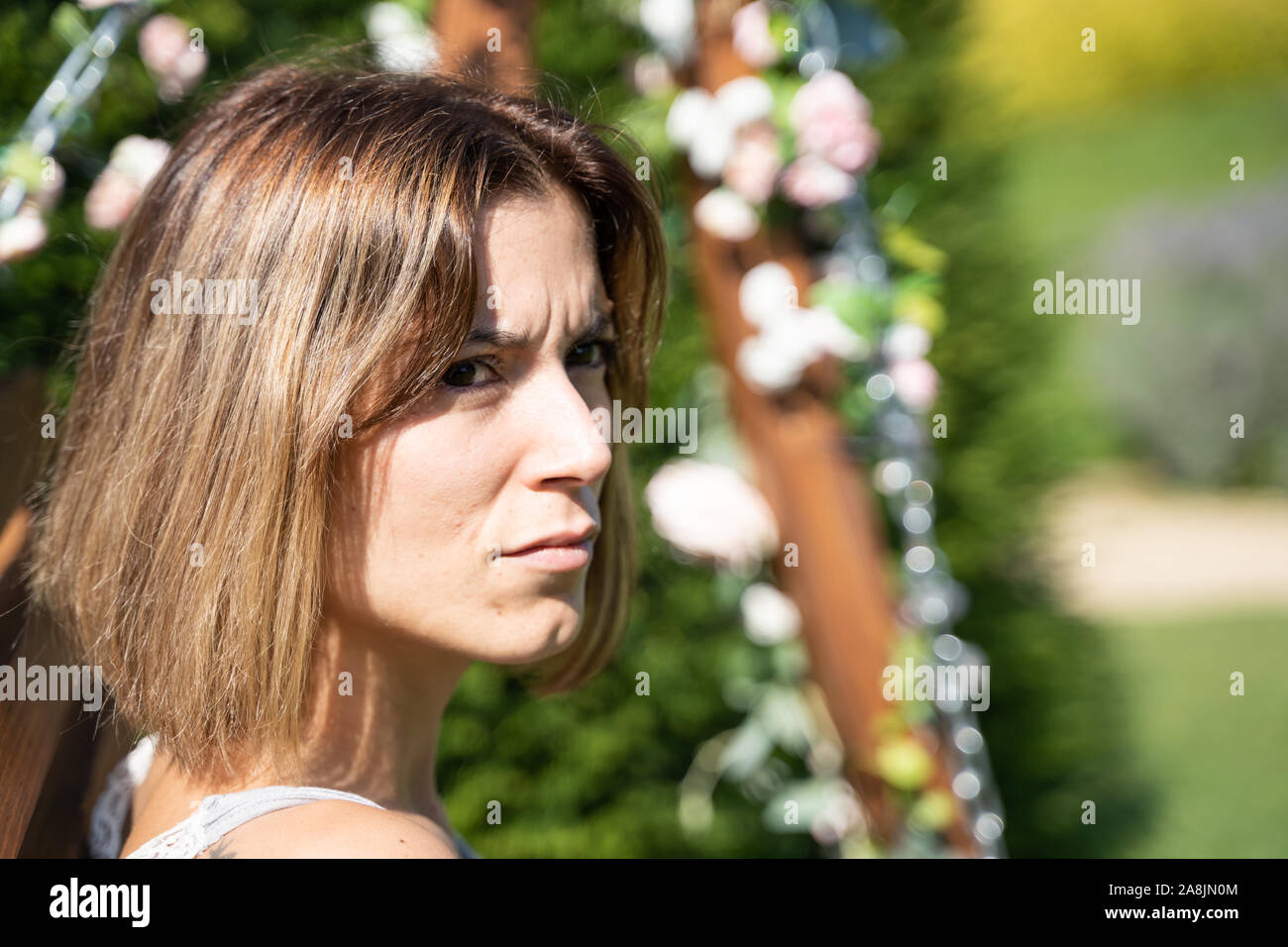 Stock photo of a girl with worried expression turning her head sitting ...