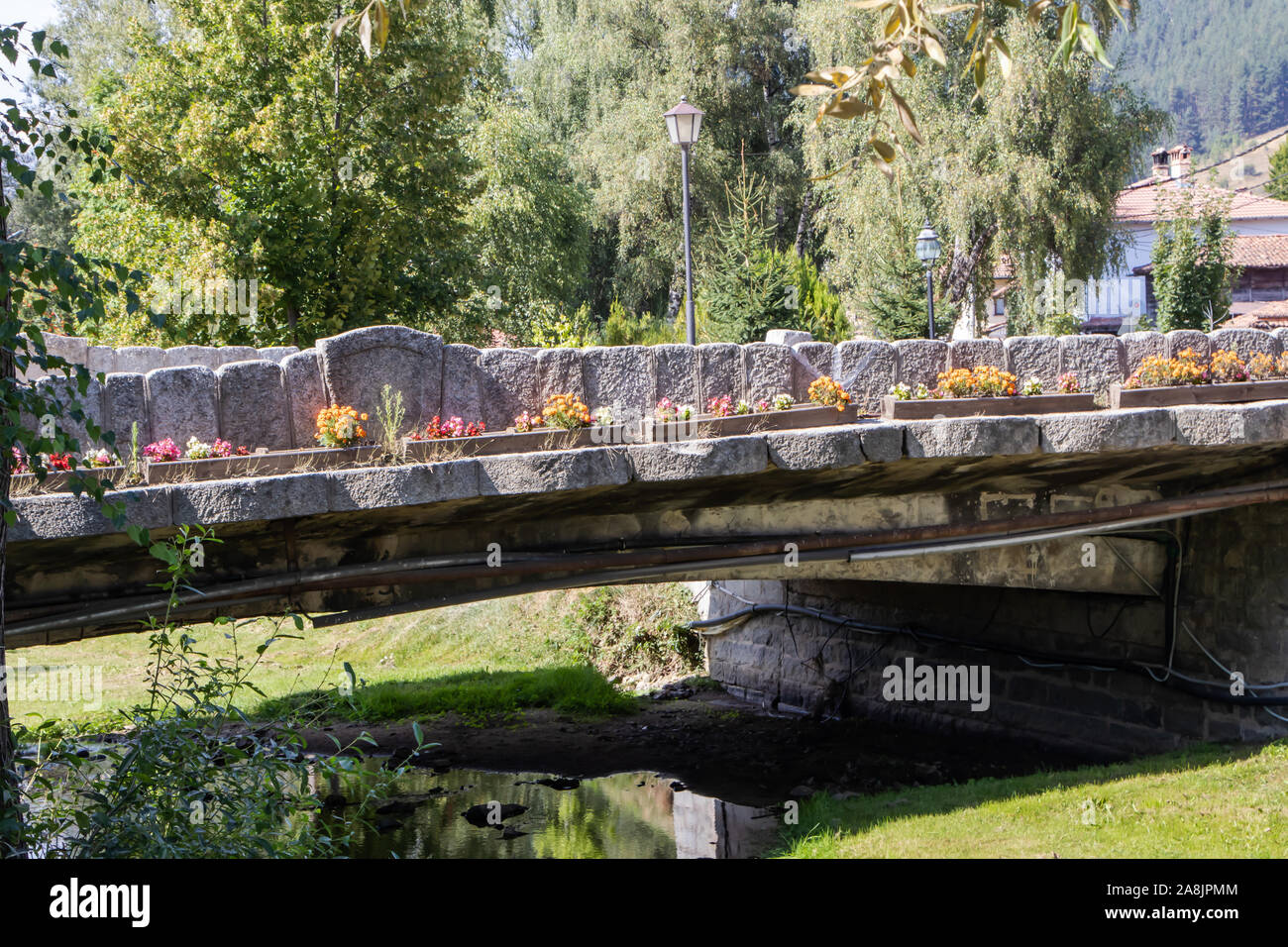 Bridge with flowers over the river Stock Photo - Alamy