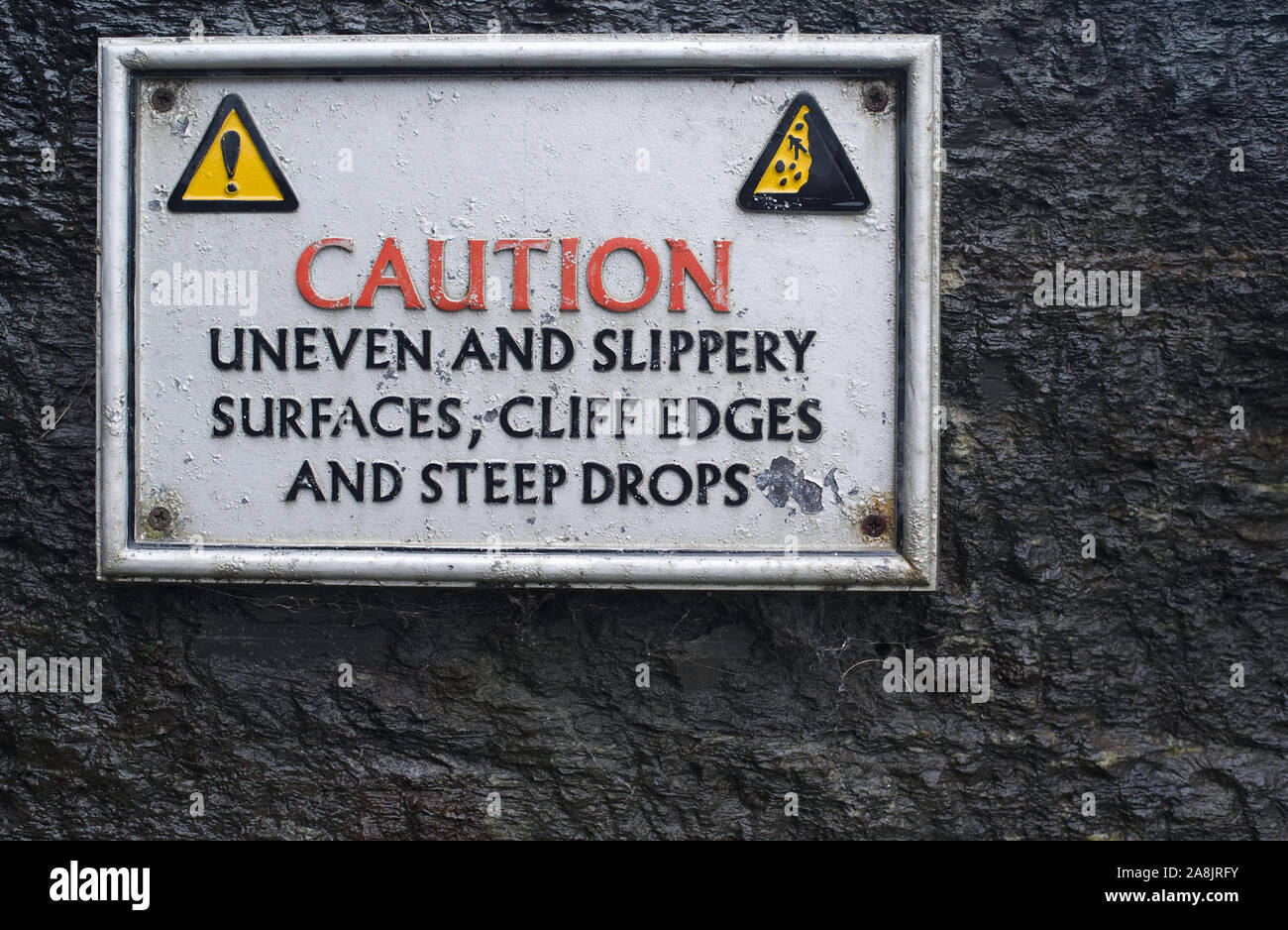 CAUTION uneven and slippery, cliff edges and steep drops surface sign ...