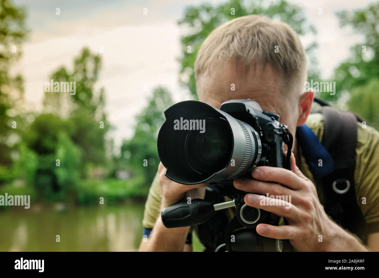 The photographer is photographing with a tripod. He is focusing on the ...