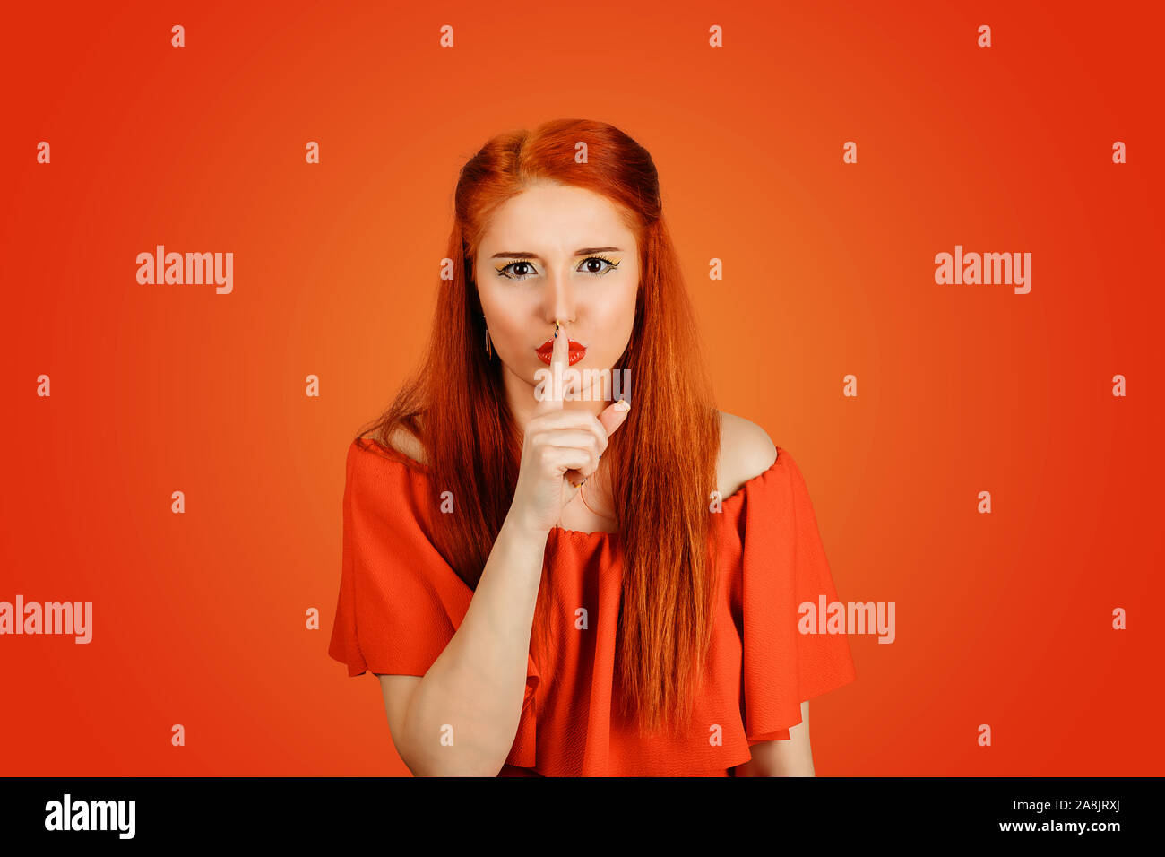 Hush Silence Gesture Closeup Of Young Redhead Woman In Red Dress
