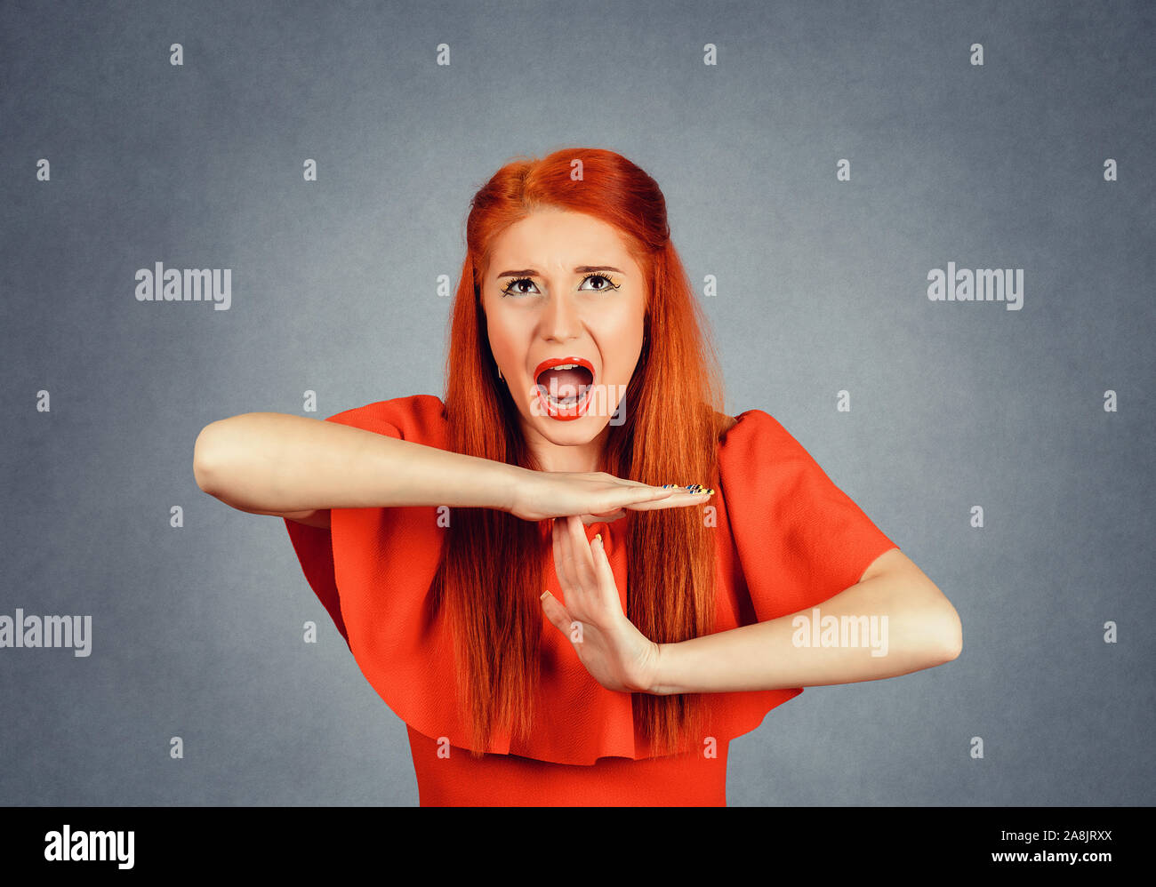 Young woman showing time out hand gesture frustrated screaming to stop ...