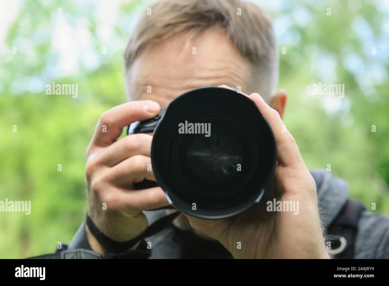 The photographer is photographing with the camera. He is focusing on ...