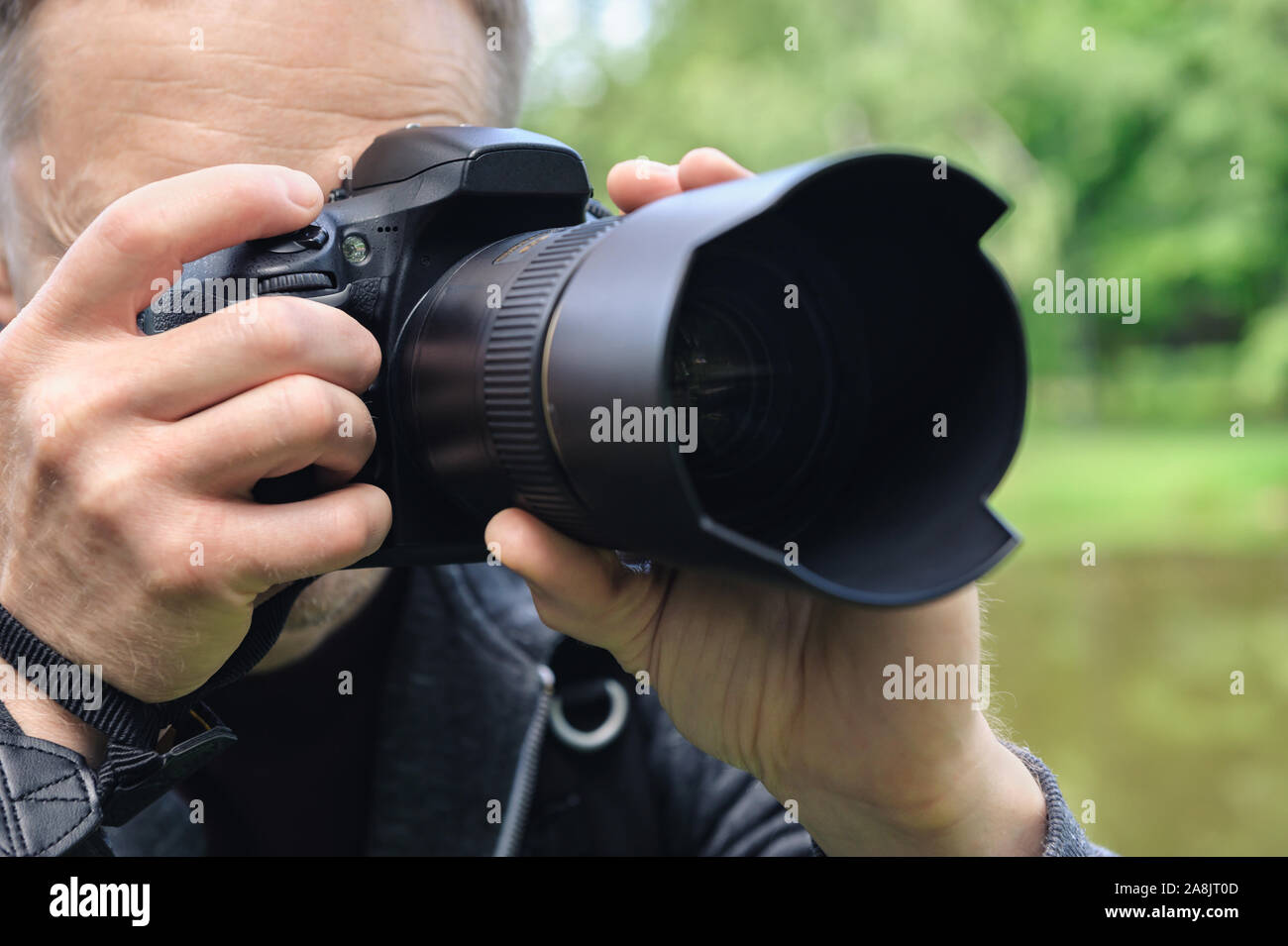 The photographer is photographing with the camera. He is focusing on ...