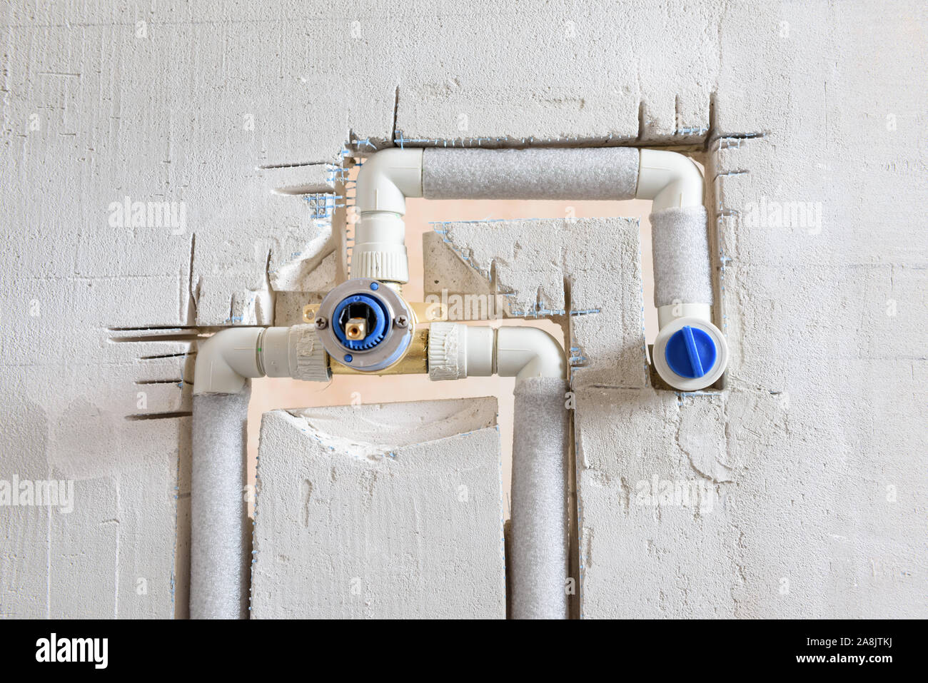 The concealed faucet with connected pipes is mounted in the wall Stock ...