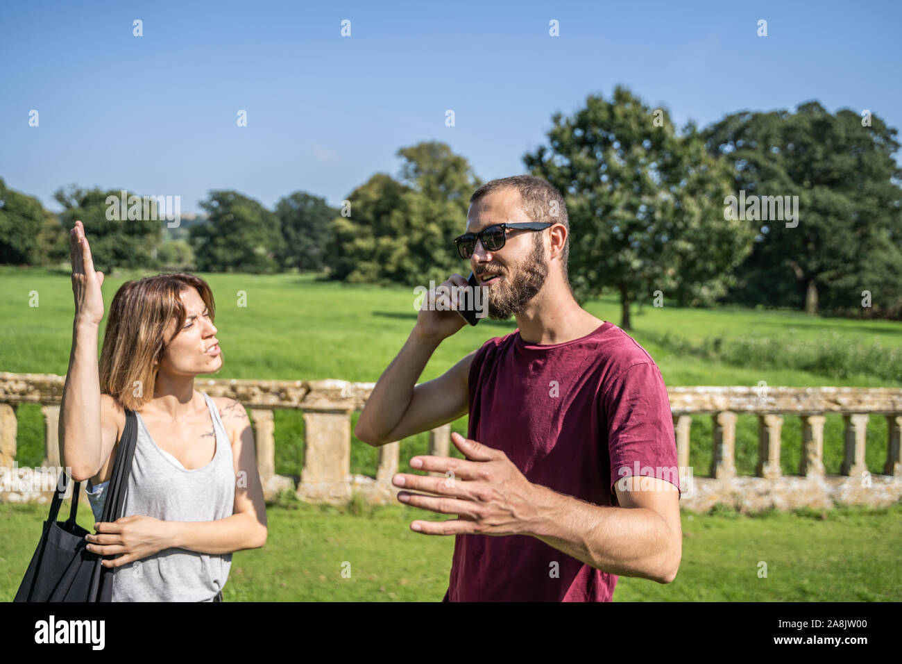 Stock photo of a girl arguing with raised hand with a boy who talks to ...