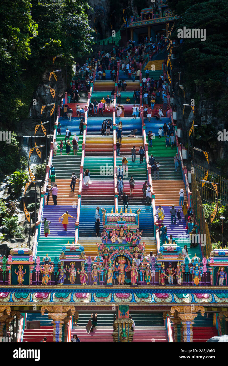 KUALA LUMPUR / MALAYSIA - May 12, 2019: Tourists ascend the colorful ...