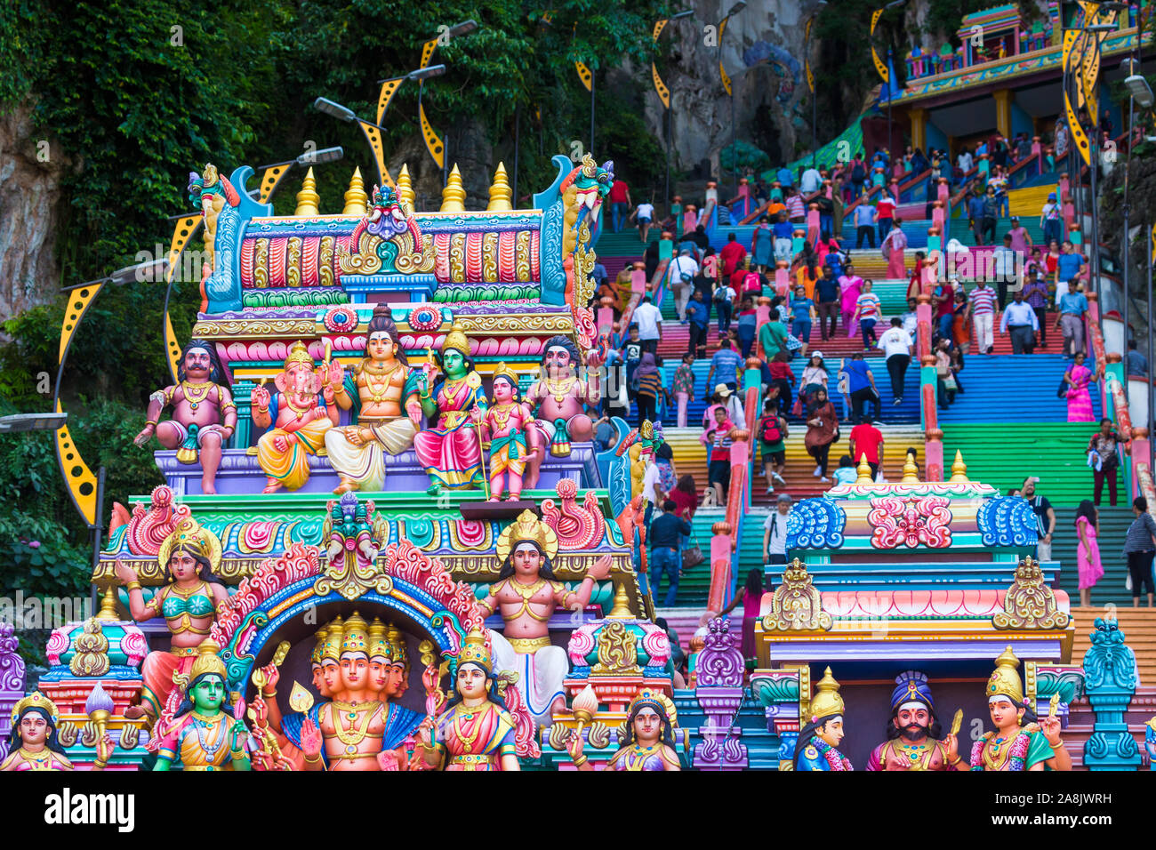 KUALA LUMPUR / MALAYSIA - May 12, 2019: Tourists ascend the colorful ...