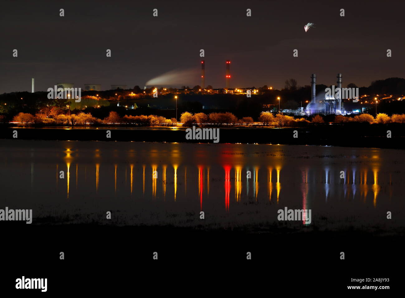 Reflections of Castleford at night in a flooded field. Cooling towers ...