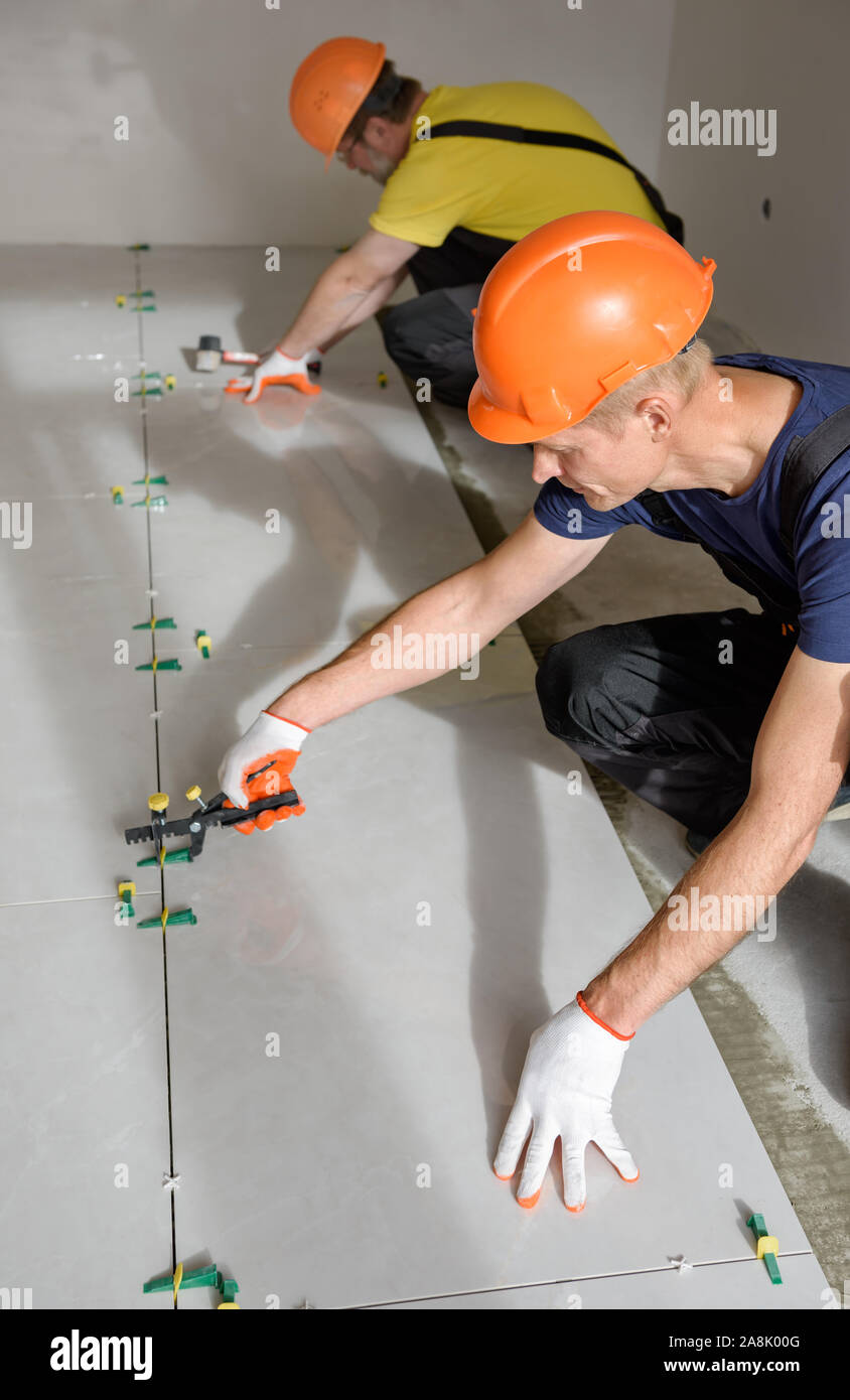 Workers laying tile hi-res stock photography and images - Alamy