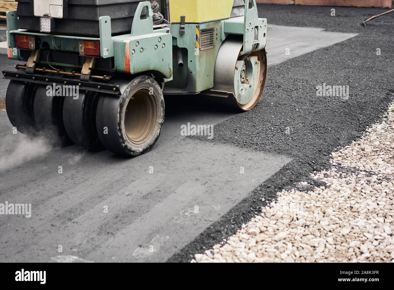 Asphalt Compactors is carrying out road repair work. Laying new asphalt ...