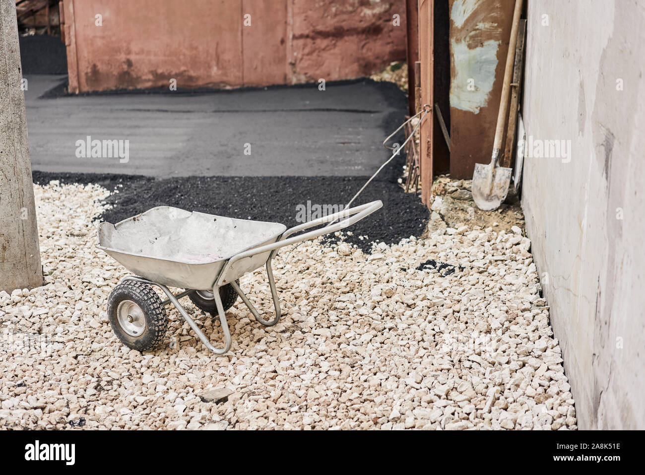 Closeup new hot asphalt. Laying asphalt, covering the pit, on the ...