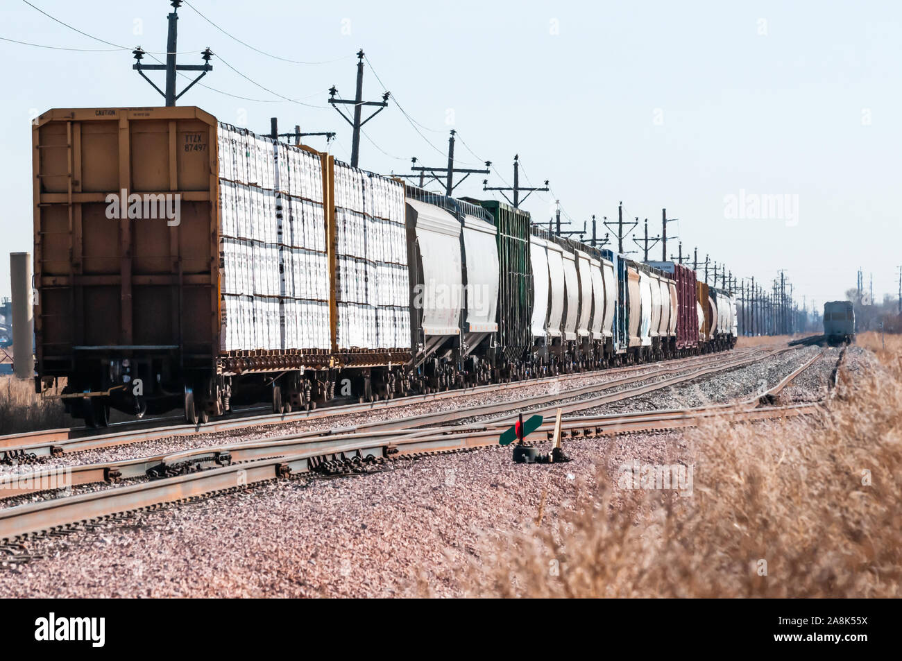 Loaded railroad cars on a siding waiting to be hauled west Stock Photo ...
