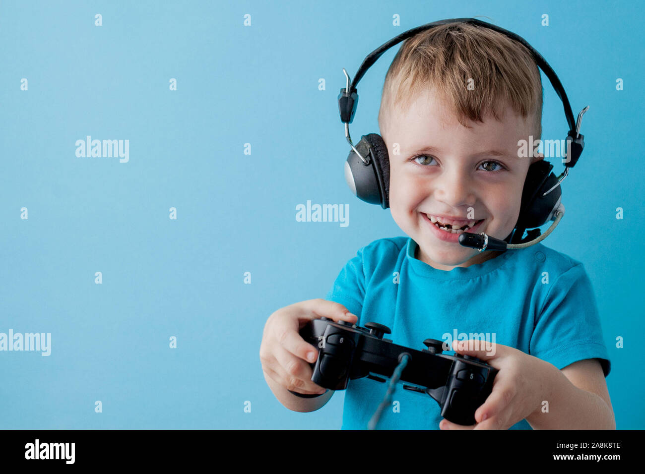 Little kid boy 2-3 years old wearing blue clothes hold in hand joystick ...