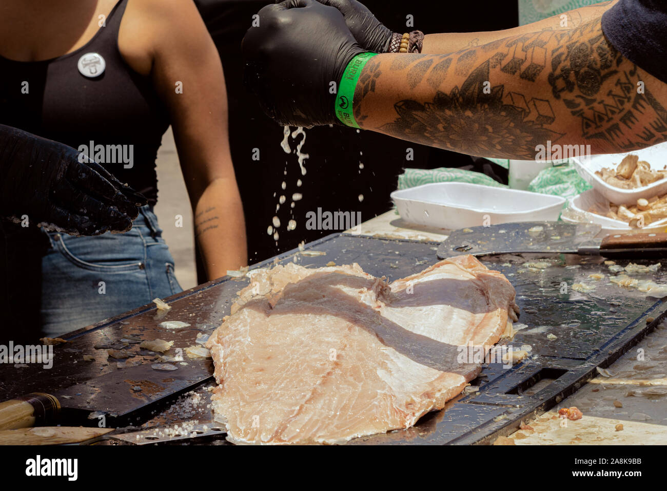 a hand squeezing lemon on top of a cut fish Stock Photo - Alamy