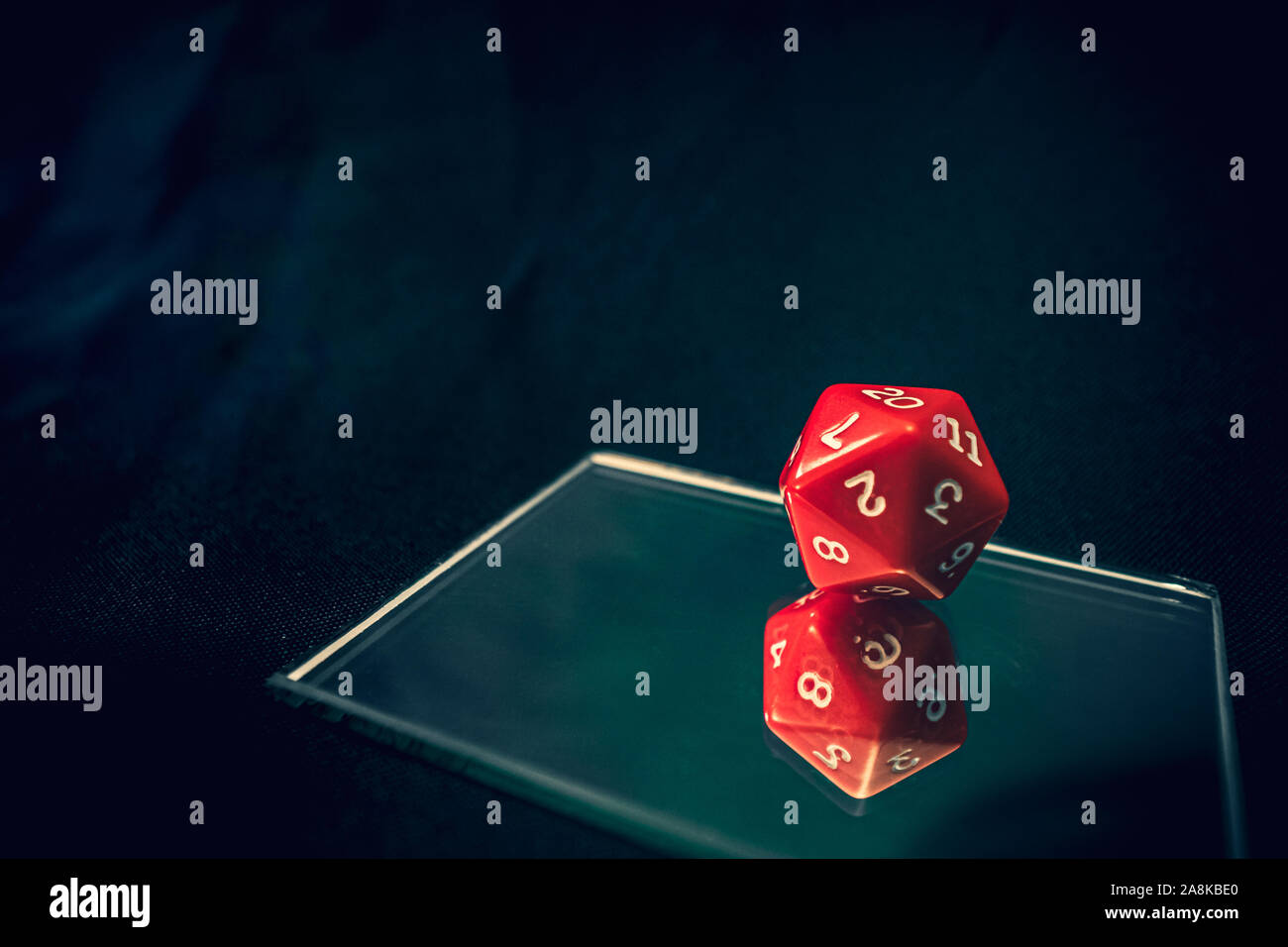 new 20 sided die with 20 faceing straight up Stock Photo - Alamy