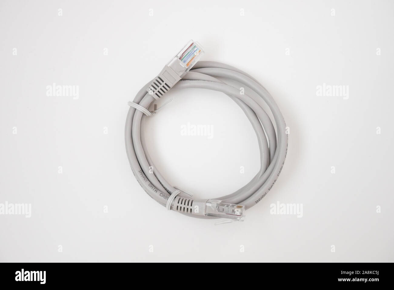 wrapped cat5 network cable against white background Stock Photo - Alamy