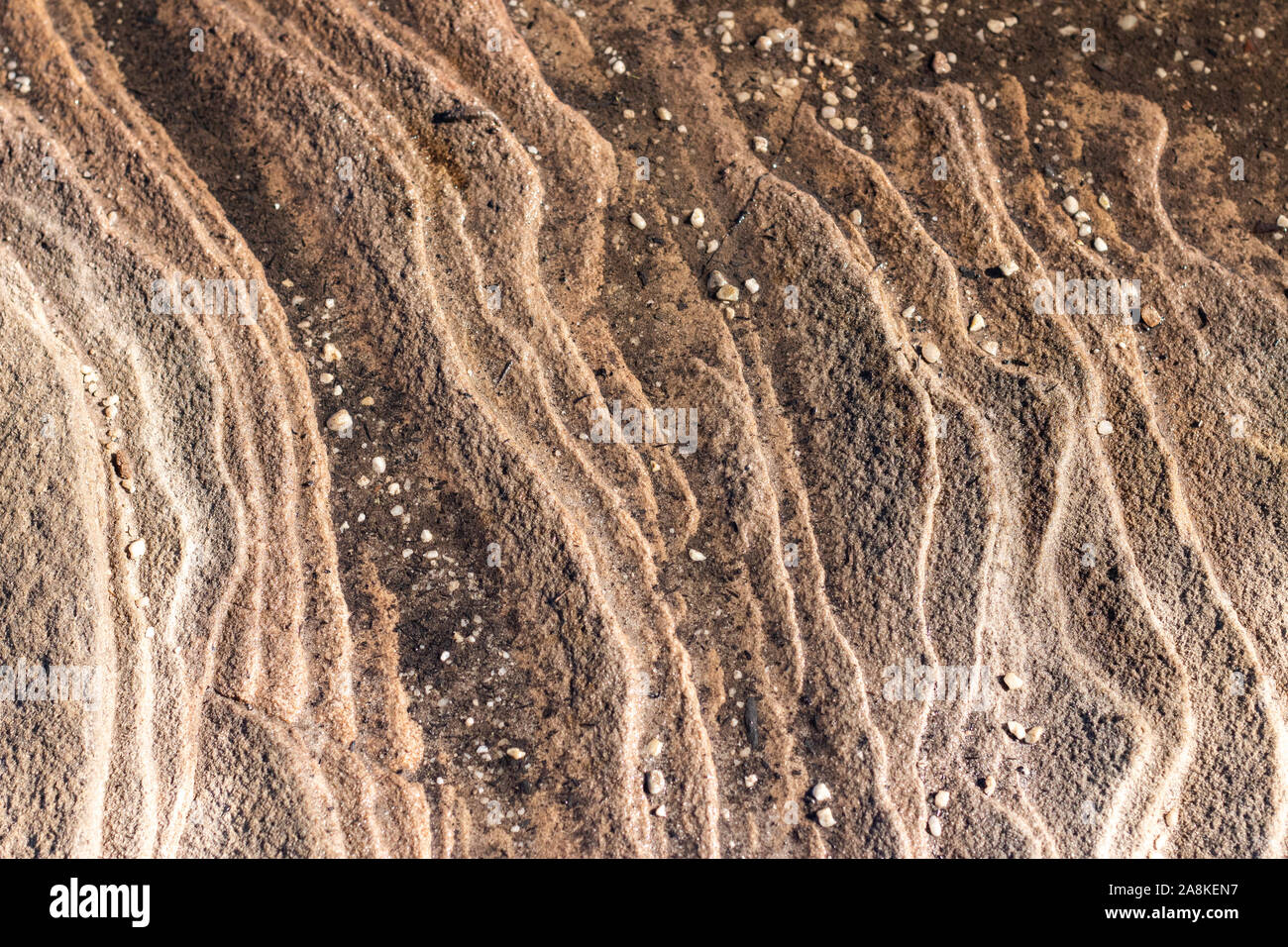 Sandstone rock face layers with pebble stones scattered ideal as ...